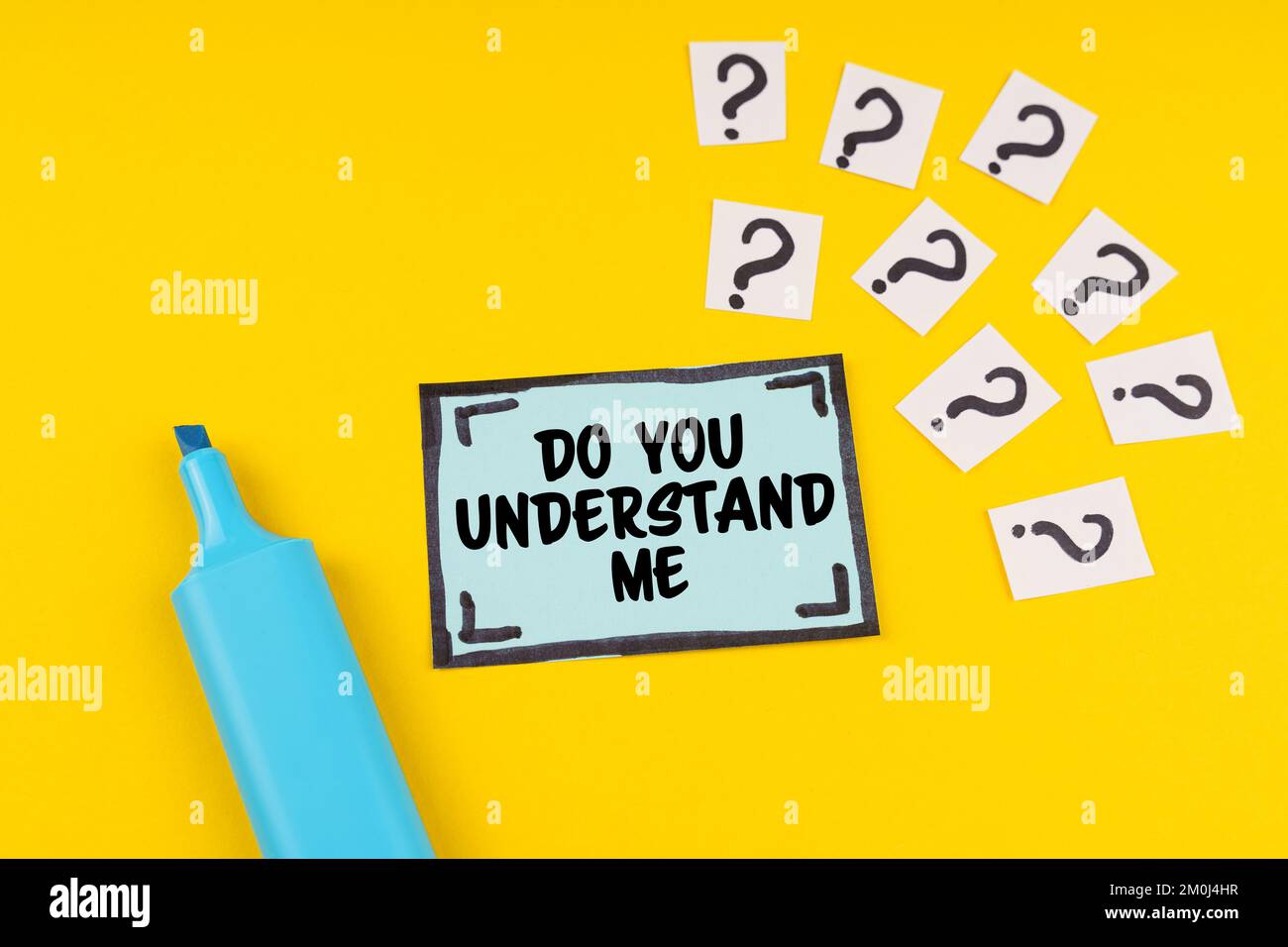 Business concept. On the yellow surface lies a blue marker, question ...