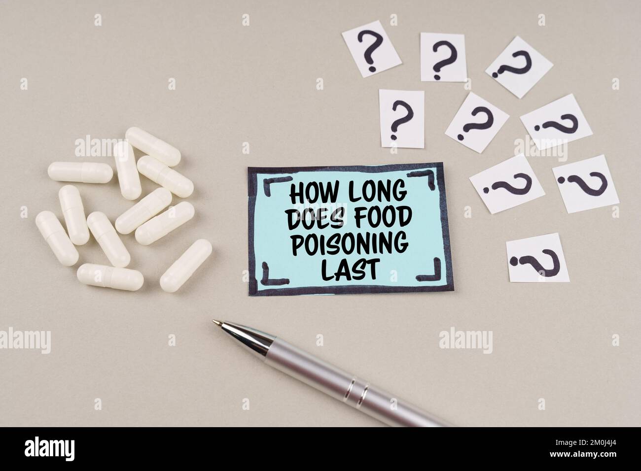 Medical concept. On a gray surface there are question marks and a blue ...