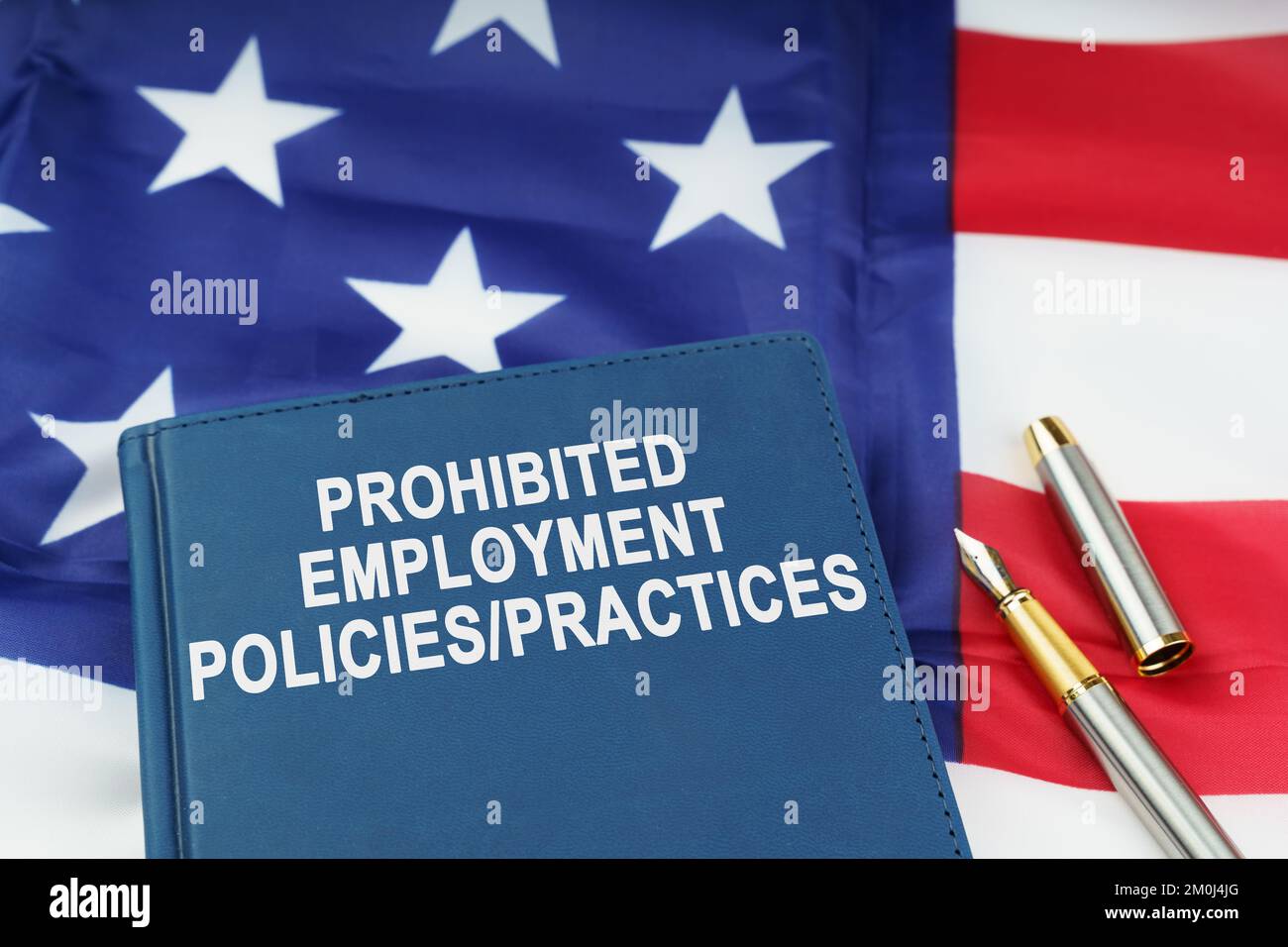 Law concept. On the US flag lies a pen and a book with the inscription ...