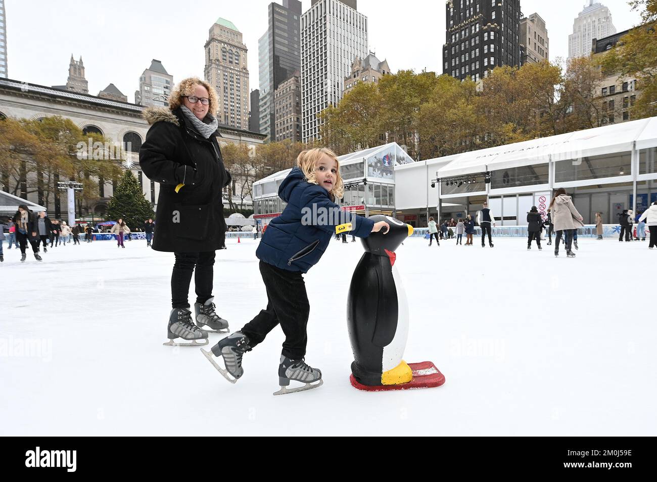 New York, USA. 06th Dec, 2022. A young girl holds on to a penguin ...