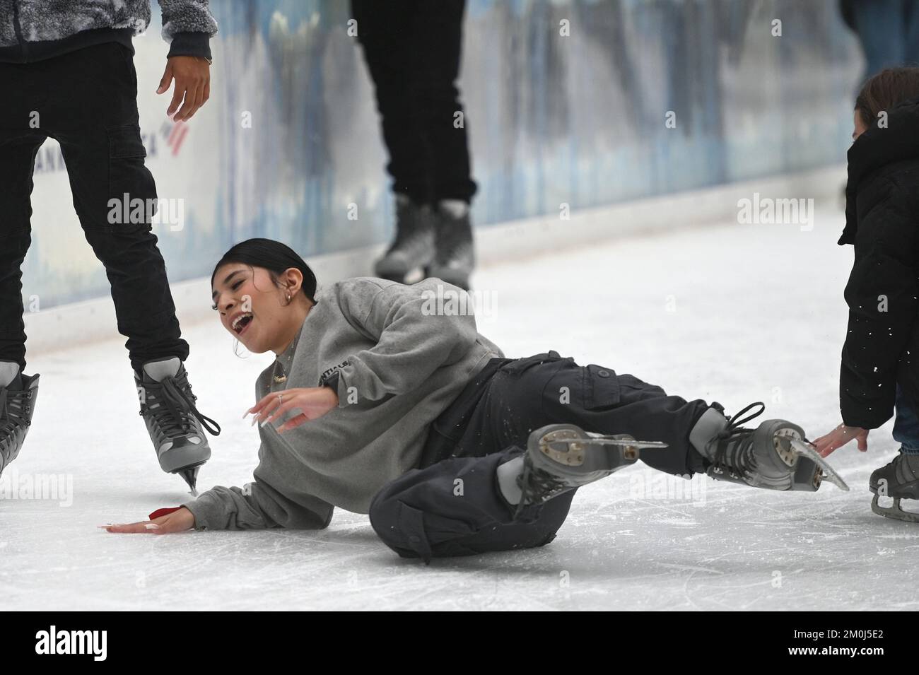 A young skater falls on the ice during an afternoon session at the Bank ...