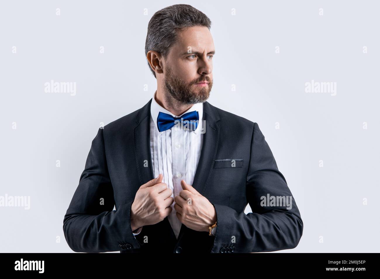 portrait of man in tux isolated on white background. tux man in studio ...