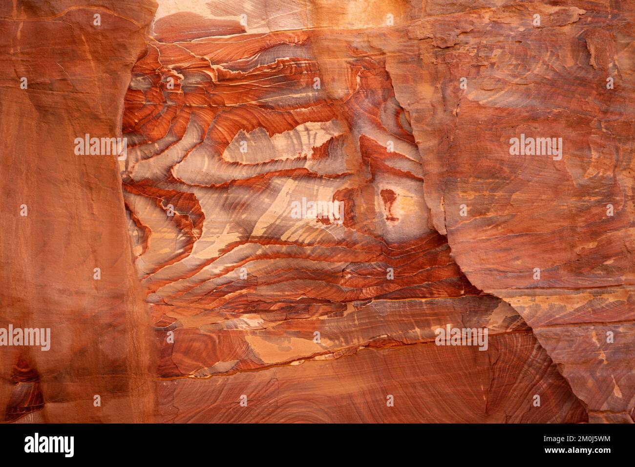 Multi-colored sandstone rock and mineral layers in ancient tombs of Petra, Jordan. Pattern ...