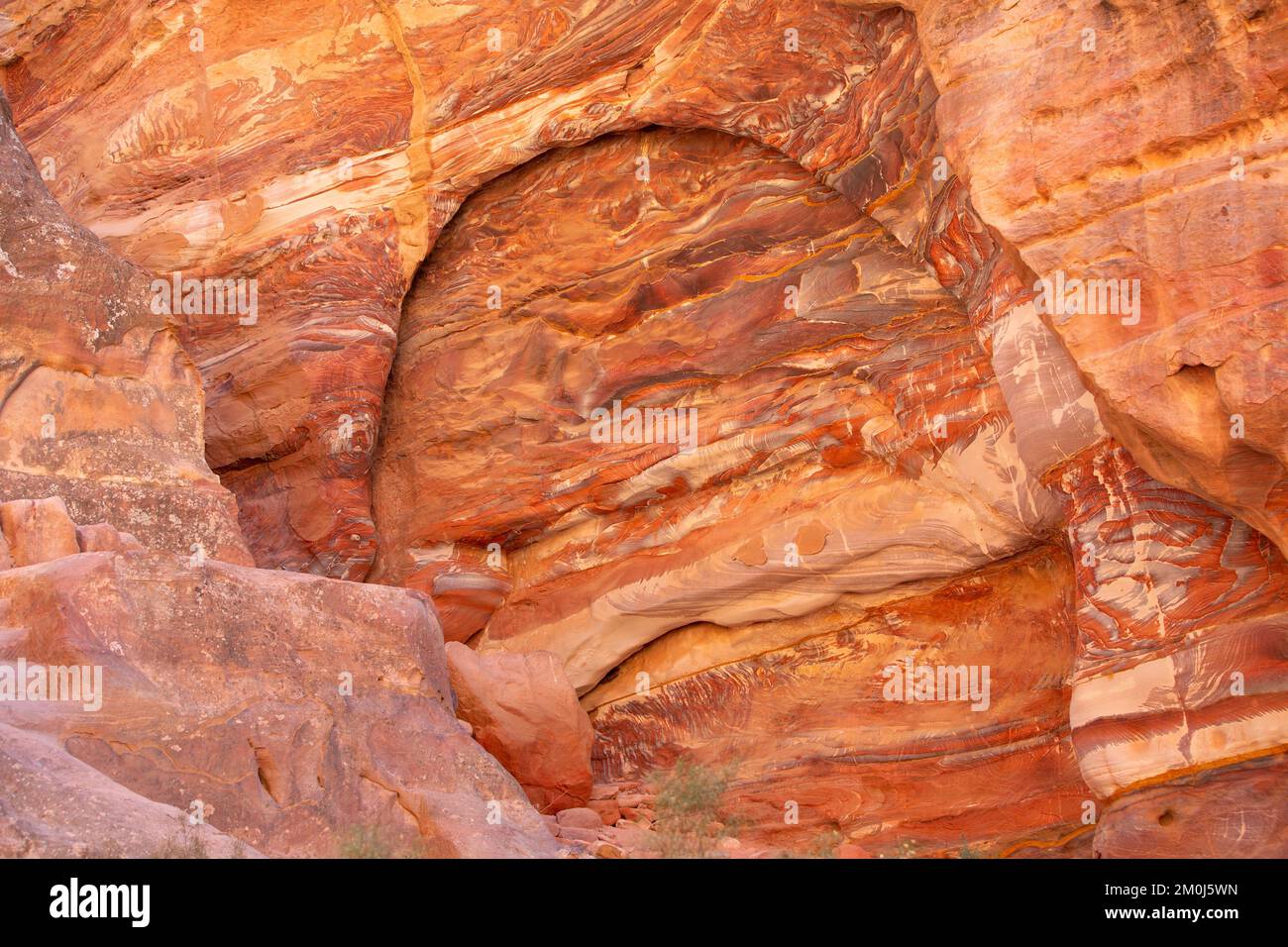 Multi-colored sandstone rock and mineral layers in ancient tombs of Petra, Jordan. Pattern ...