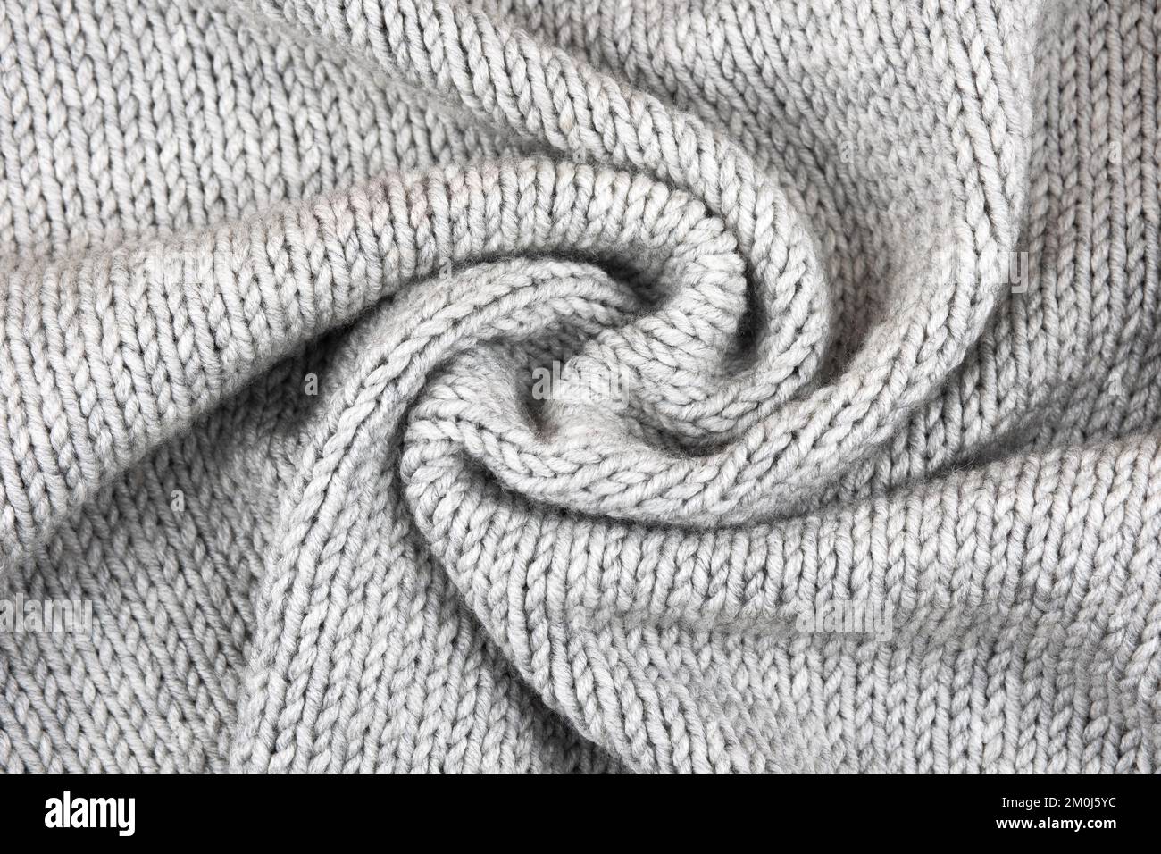 Knitted gray background. Close-up of a knitted blanket. Wavy folds ...