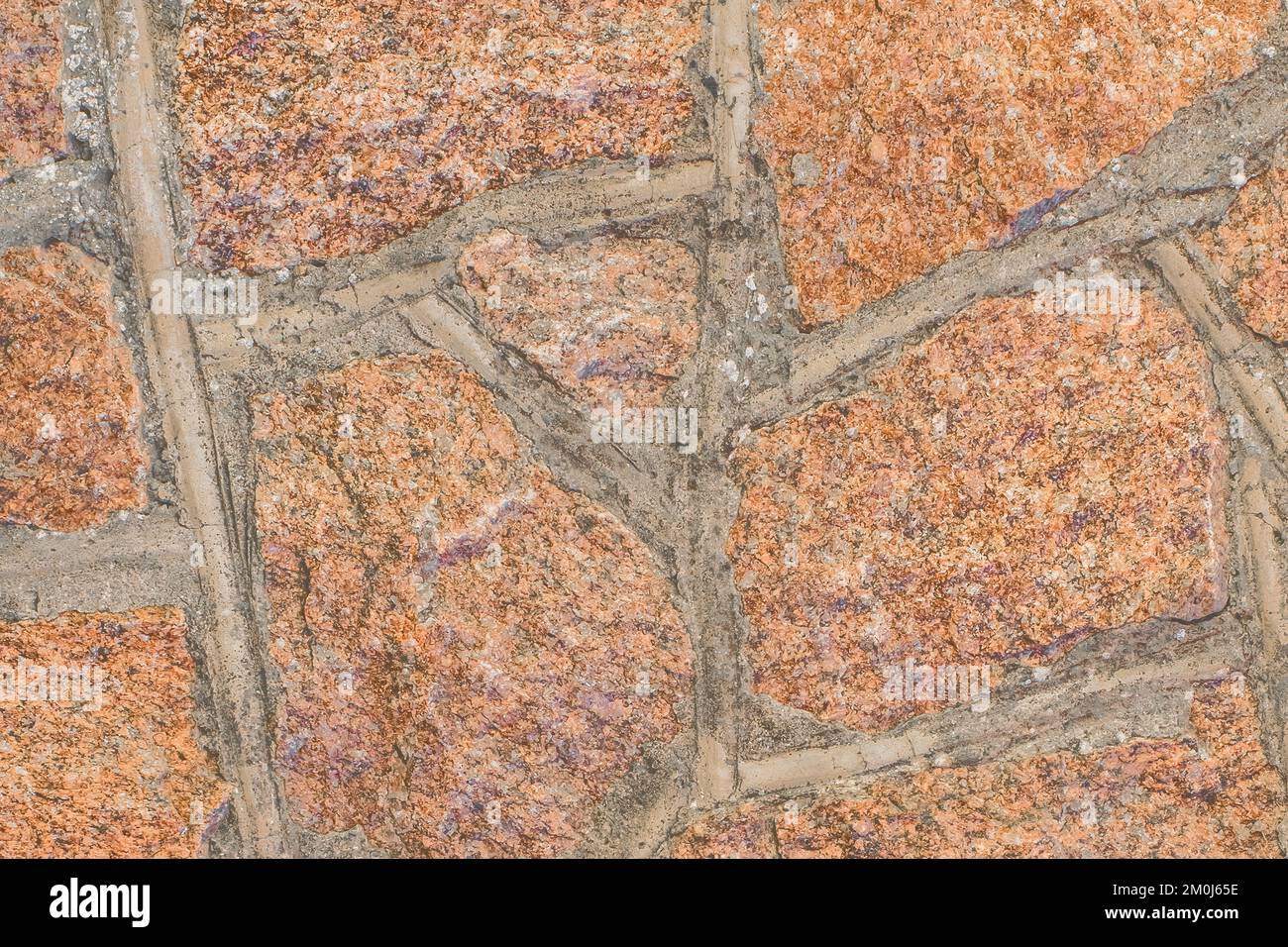 Red and brown stone cobblestone wall texture background Stock Photo - Alamy