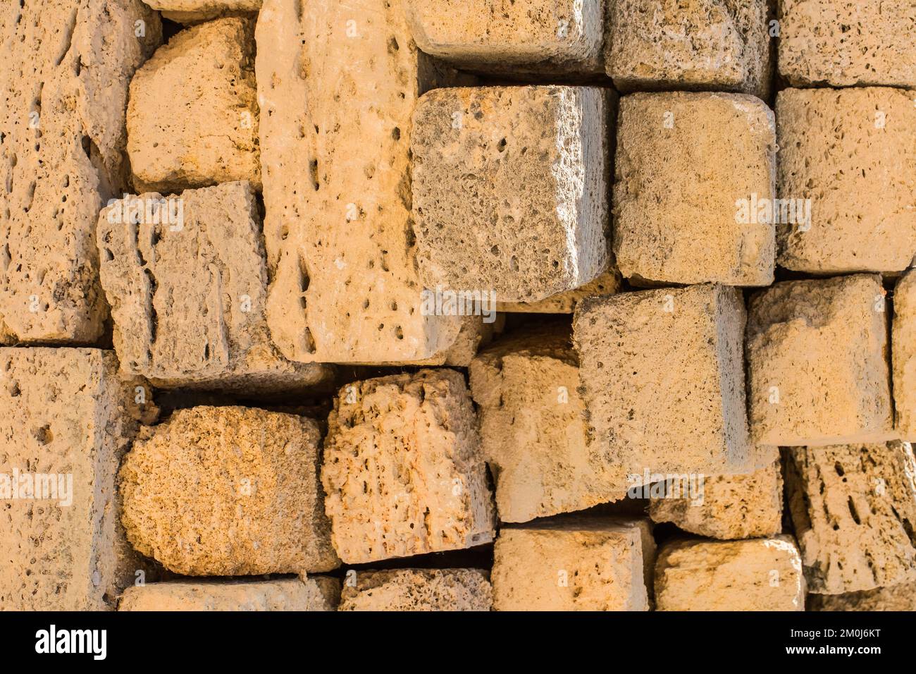 A pile of brick coquina blocks of shell sand stone material close-up ...