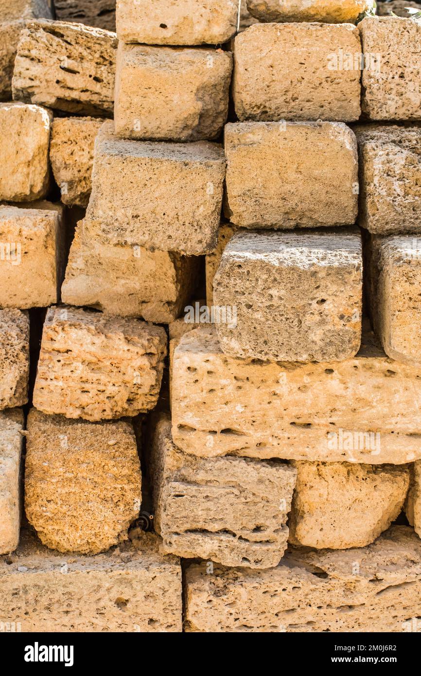 A pile of brick coquina blocks of shell sand stone material close-up ...