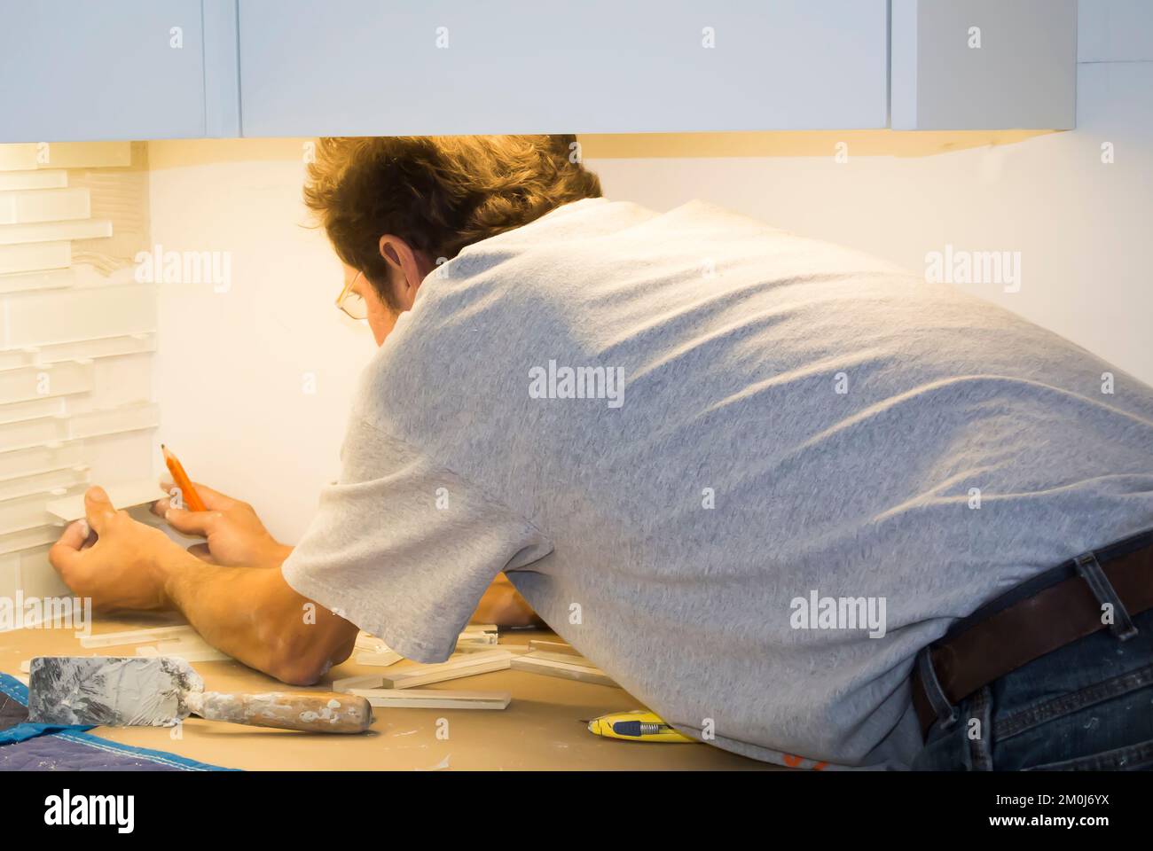 Construction - Installation of Backsplash in Kitchen Remodel Stock ...