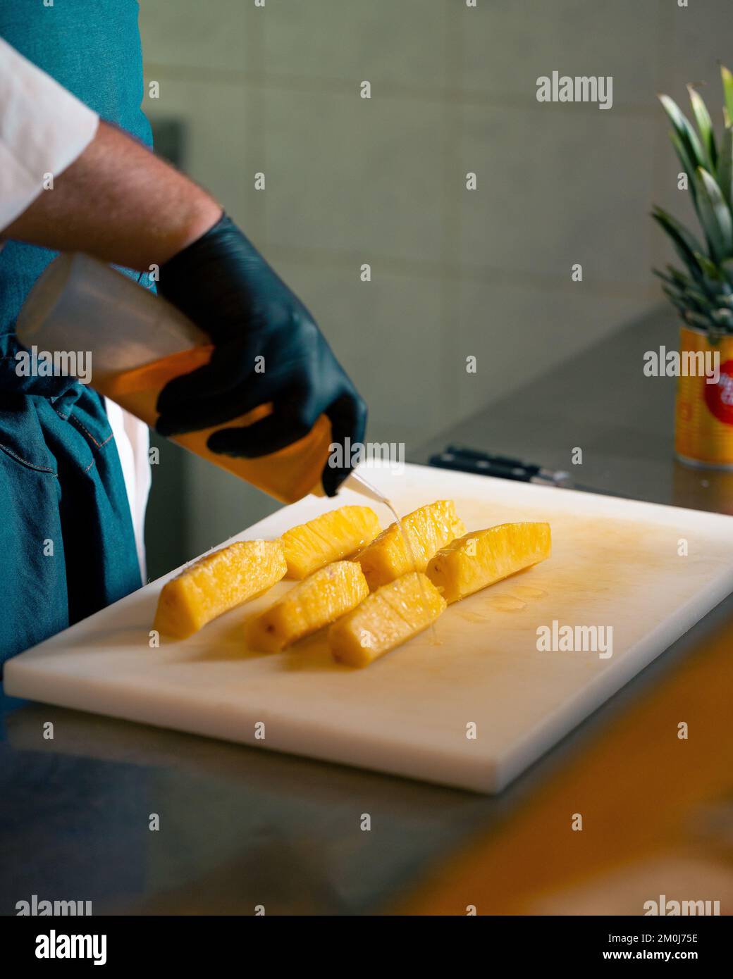 a closeup of a chef preparing pineapple cut in a restaurant Stock Photo ...