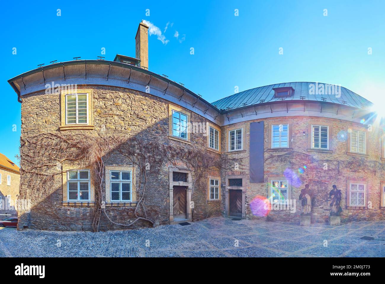 The facade of the stone Dvorakovo Museum in bright sun rays, Kolin ...