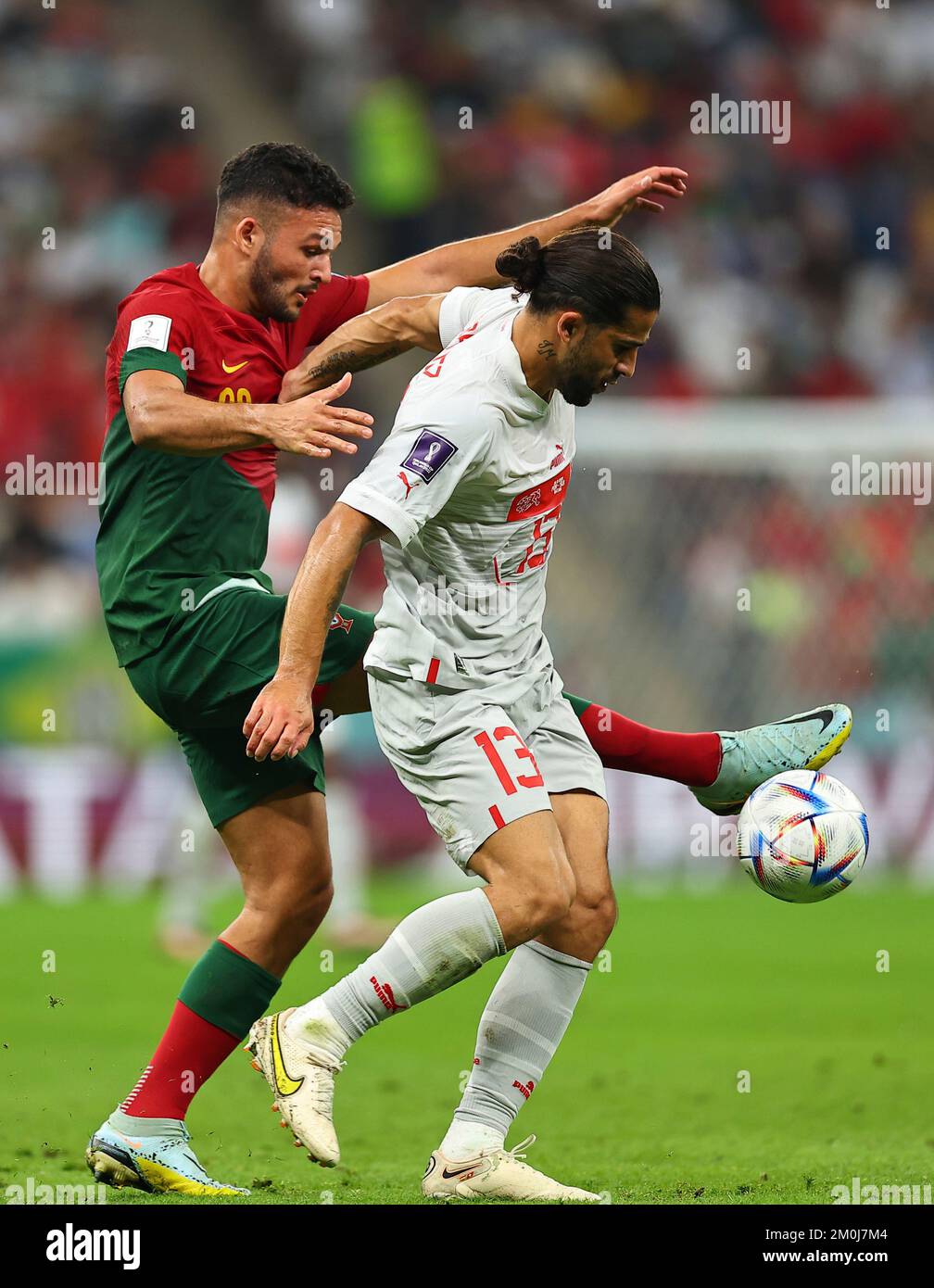 Lusail, Qatar. 6th Dec, 2022. Goncalo Ramos (L) of Portugal vies with ...