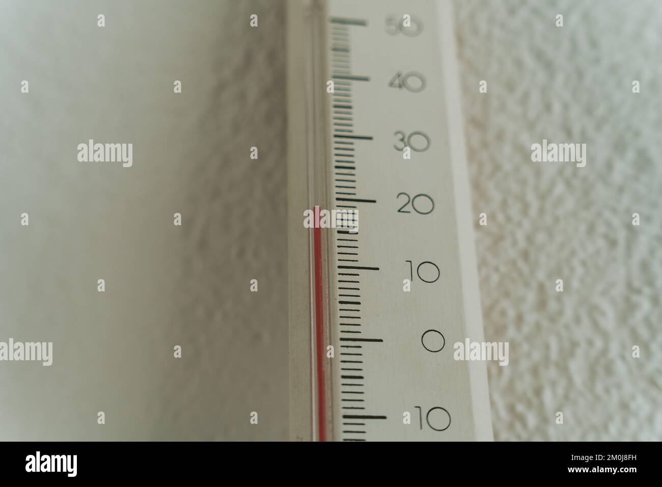 A closeup of the facade of a thermometer showing temperature in a room ...