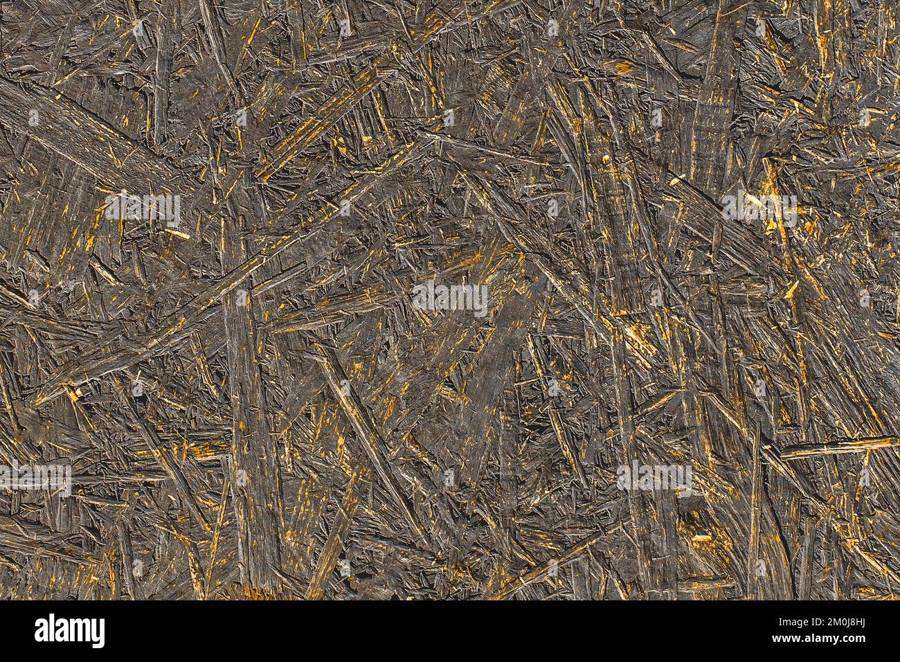 Dark paint on abstract surface of pressed wood chipboard texture ...