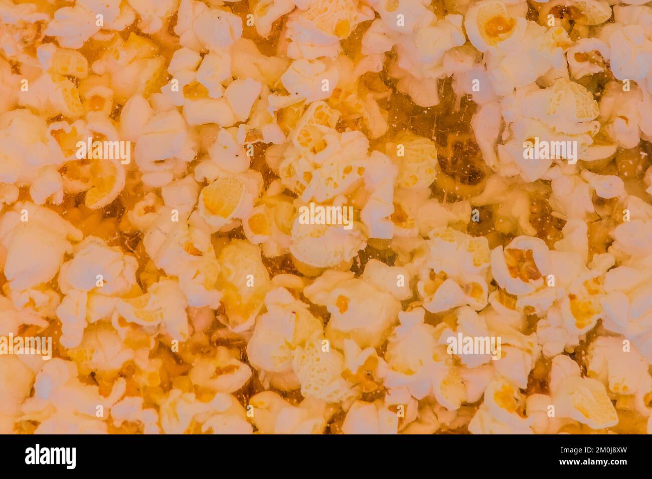 Orange color sweet popcorn, crunchy corn snack background Stock Photo ...