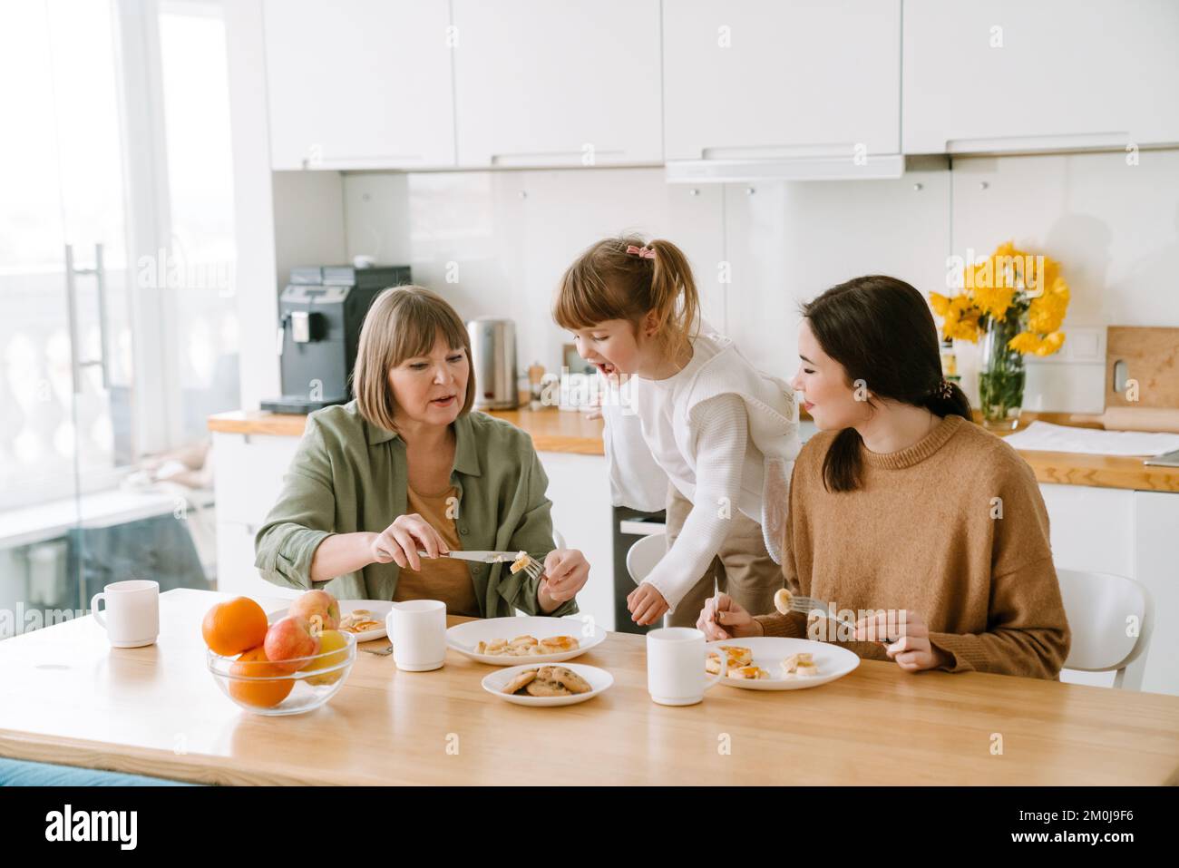 White family having breakfast while spending time together at home ...