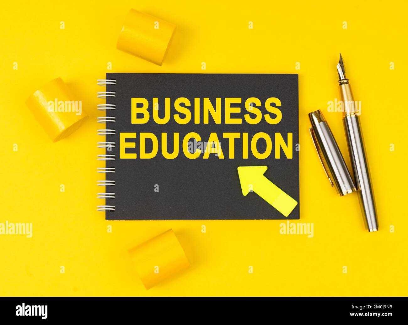 Business and finance concept. On a yellow background lies a pen, a ...