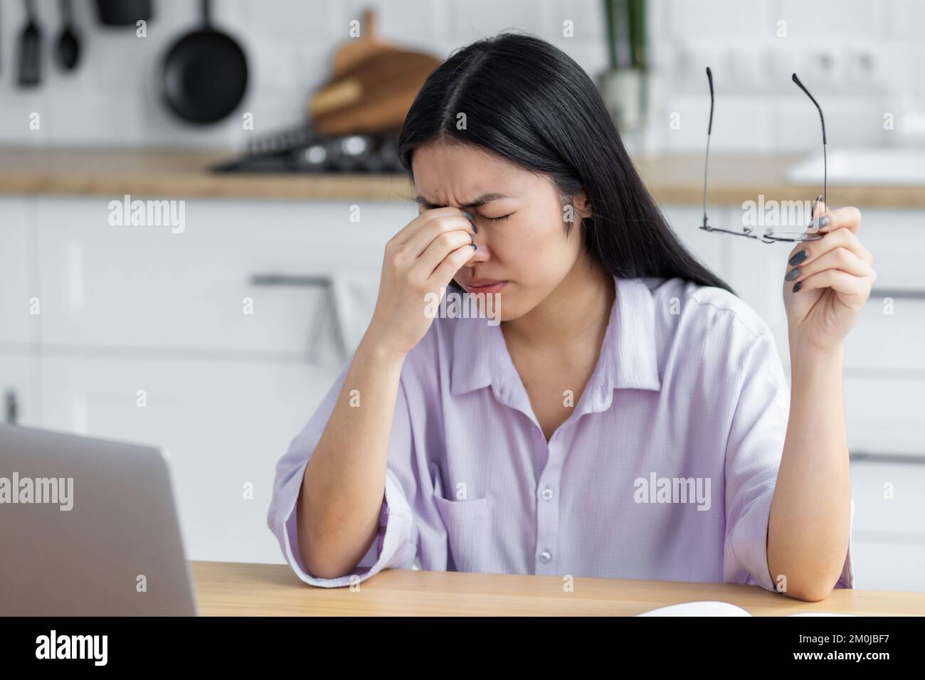 Tired stressed Asian woman freelancer or student having headache ...