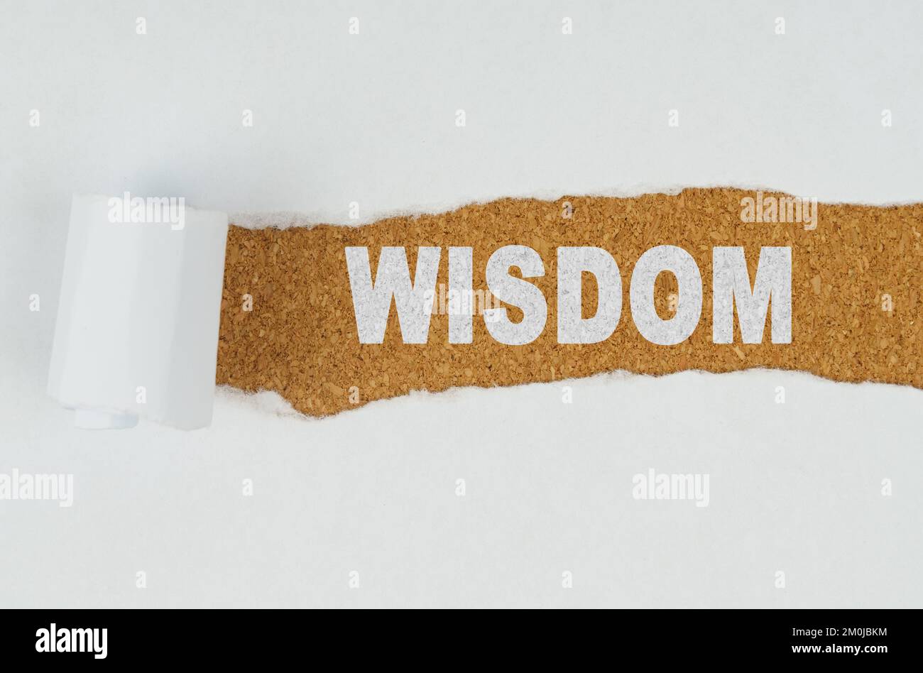 Business and finance. Behind torn white paper on a wooden background ...