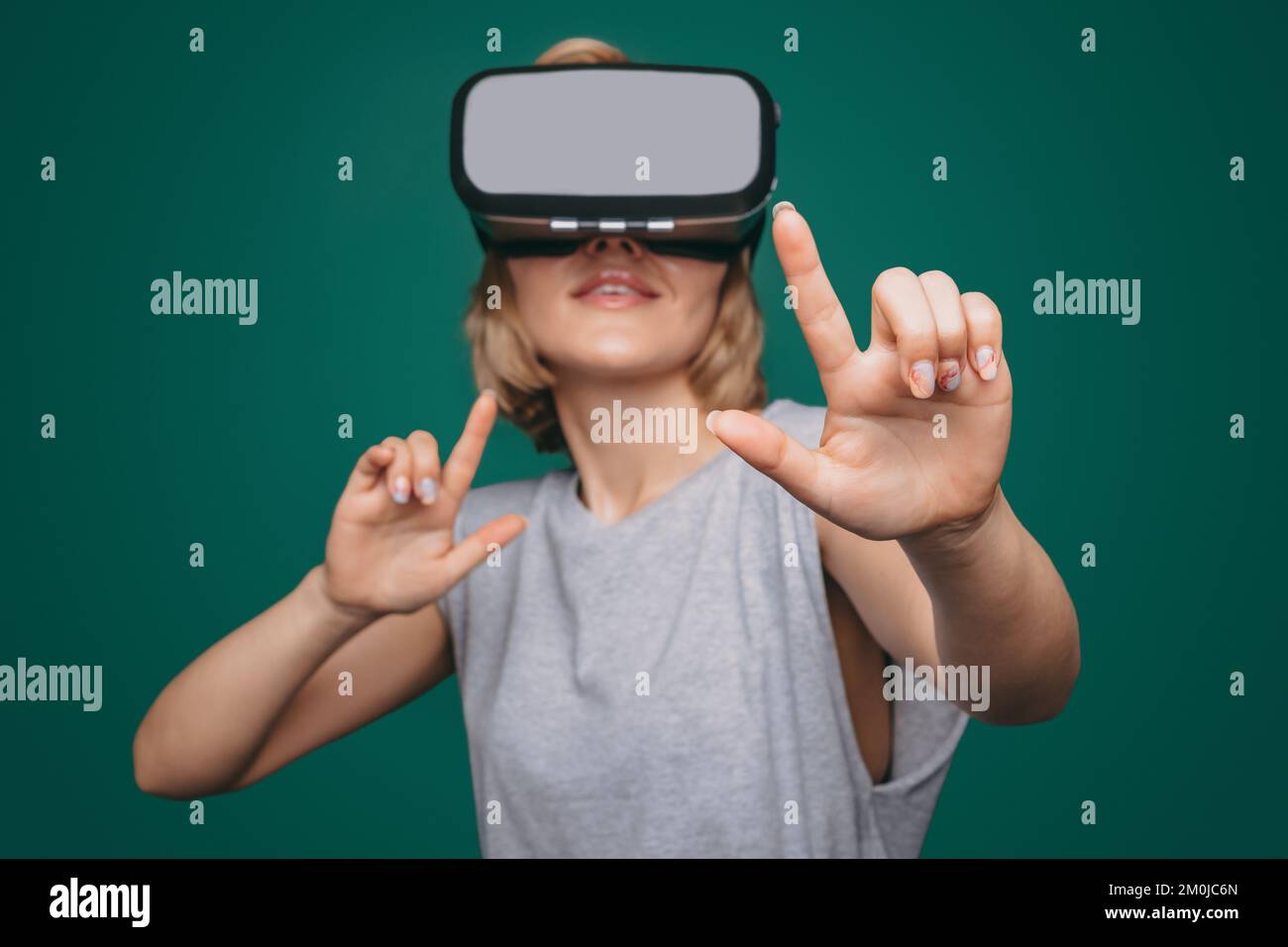 Caucasian woman in VR headset exploring new worlds in videogame ...