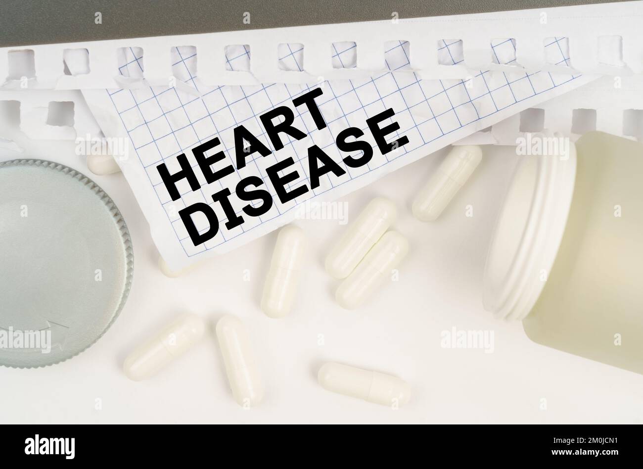 Medicine and health concept. On the table is an open jar of pills and a ...