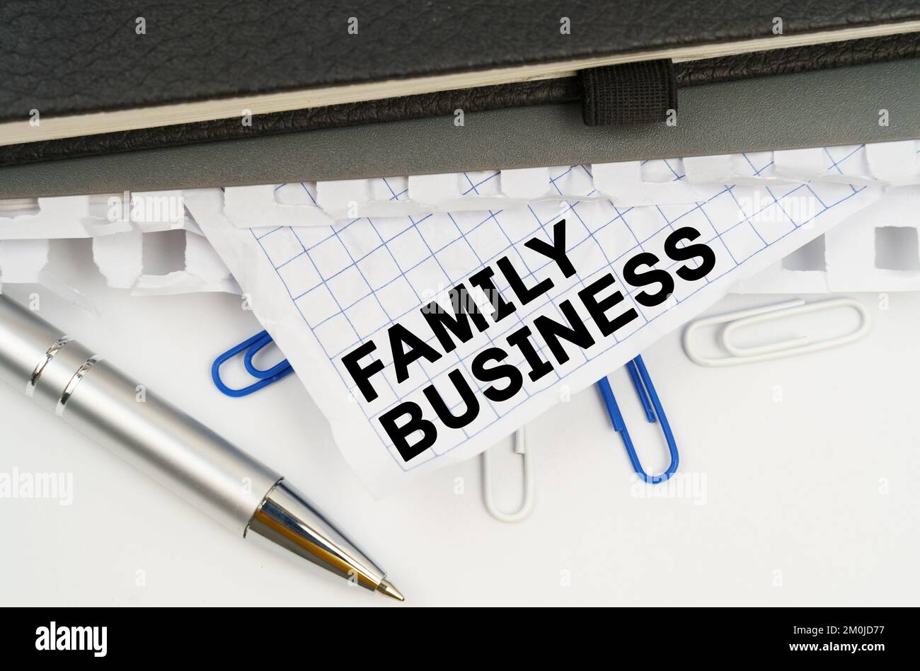 Business concept. On the table is a pen, notebooks and a crumpled sheet ...