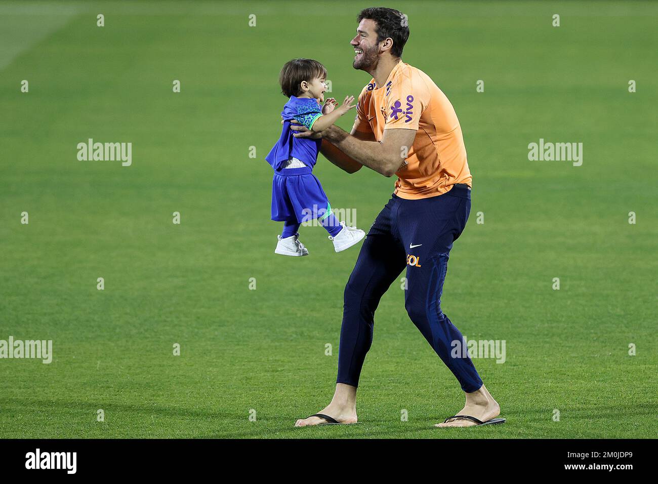 Alisson Becker of Brazil plays with children during Brazil training ...