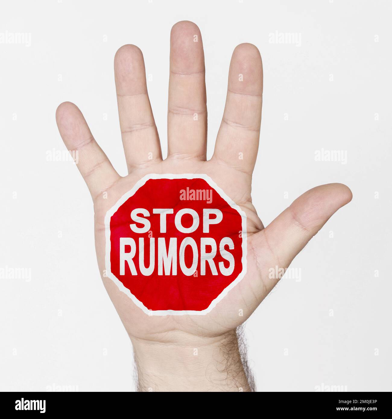 On the palm of the hand there is a stop sign with the inscription ...