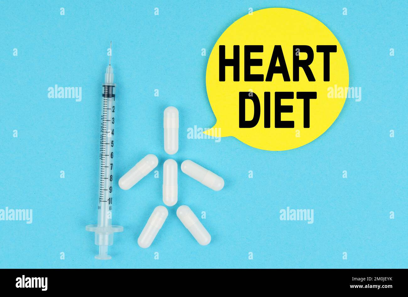 Medicine and health concept. Syringe, human figure made of pills and ...