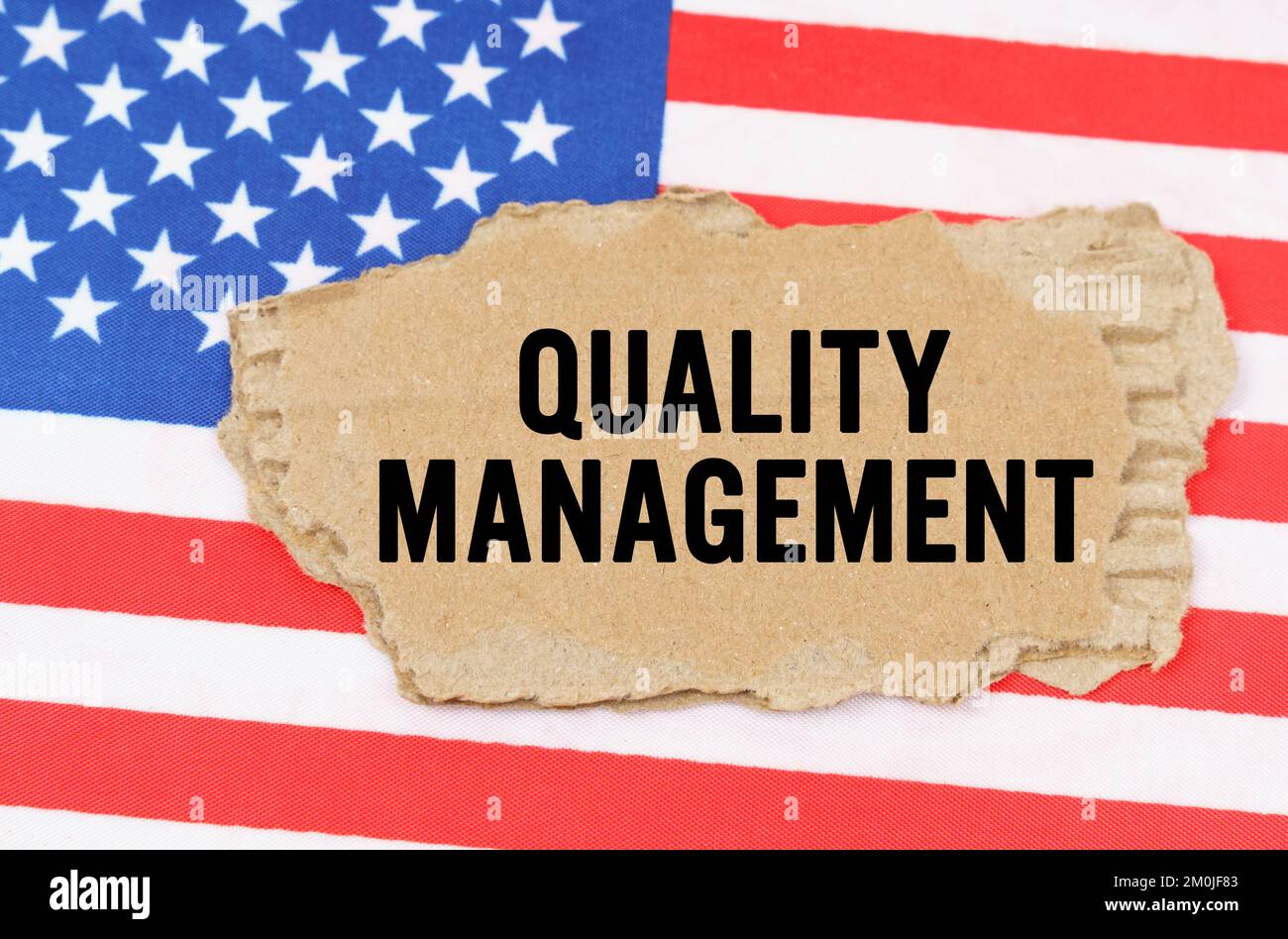 Business and finance concept. On the US flag lies a cardboard box with ...
