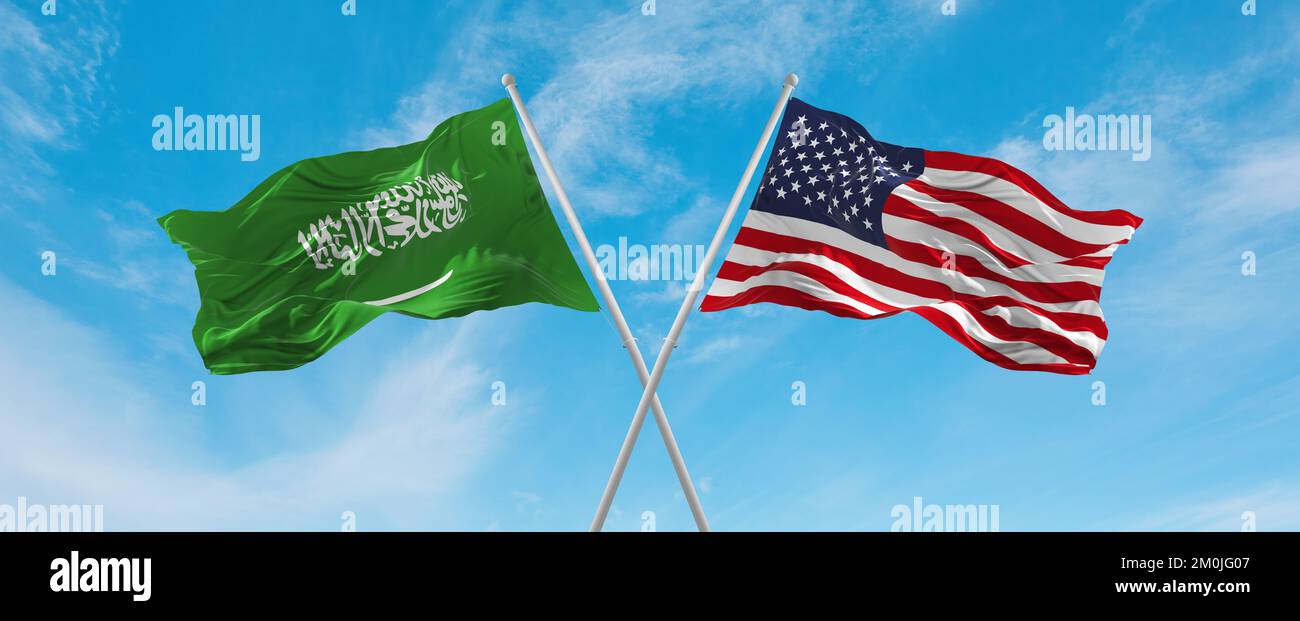 two crossed flags United States of America and Saudi Arabia waving in ...