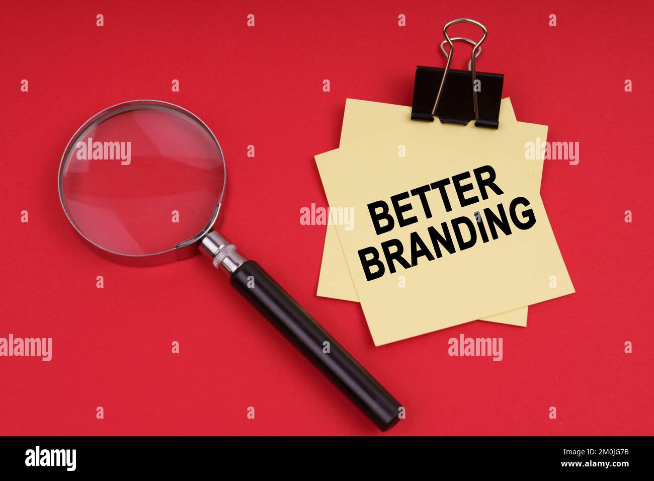 Business and Economics. On a red background, a magnifying glass and a ...