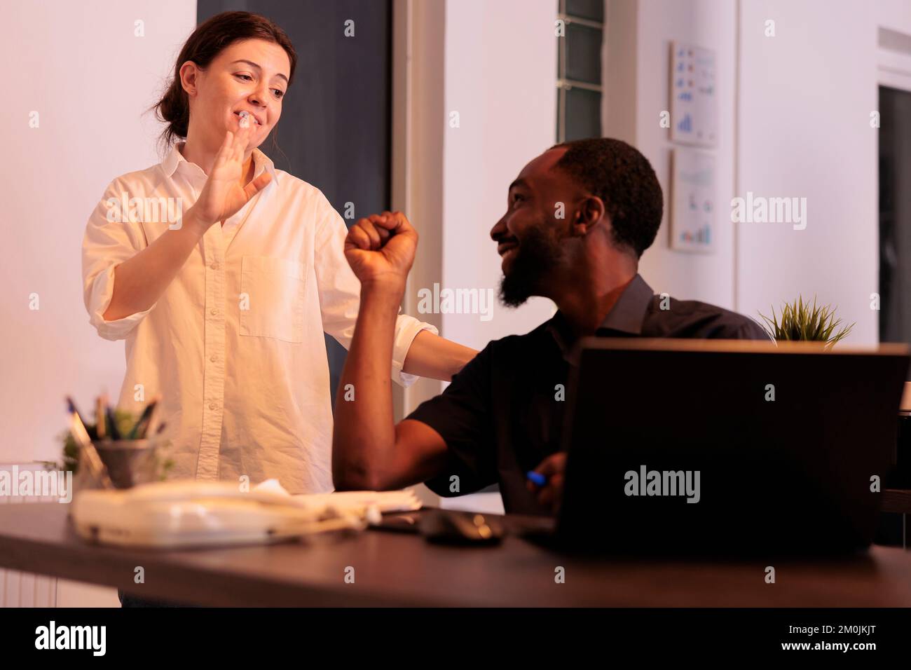 Two employees giving high five, celebrating successful teamwork result ...