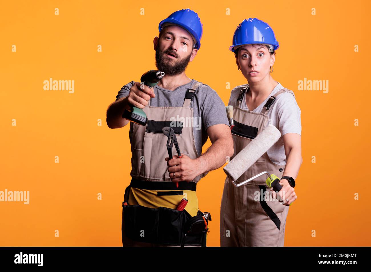 Professional renovators showing construction tools in studio shot ...