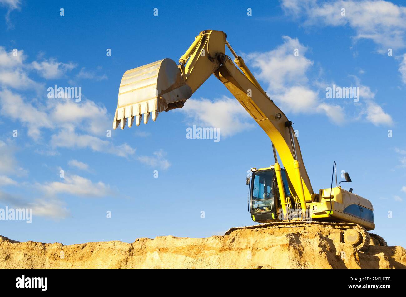Solitary yellow digger in a quarry Stock Photo - Alamy