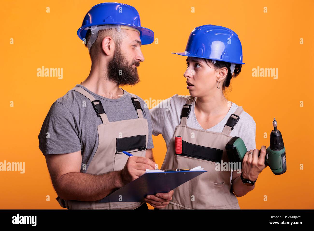 Construction experts taking notes on clipboard and checking renovation ...