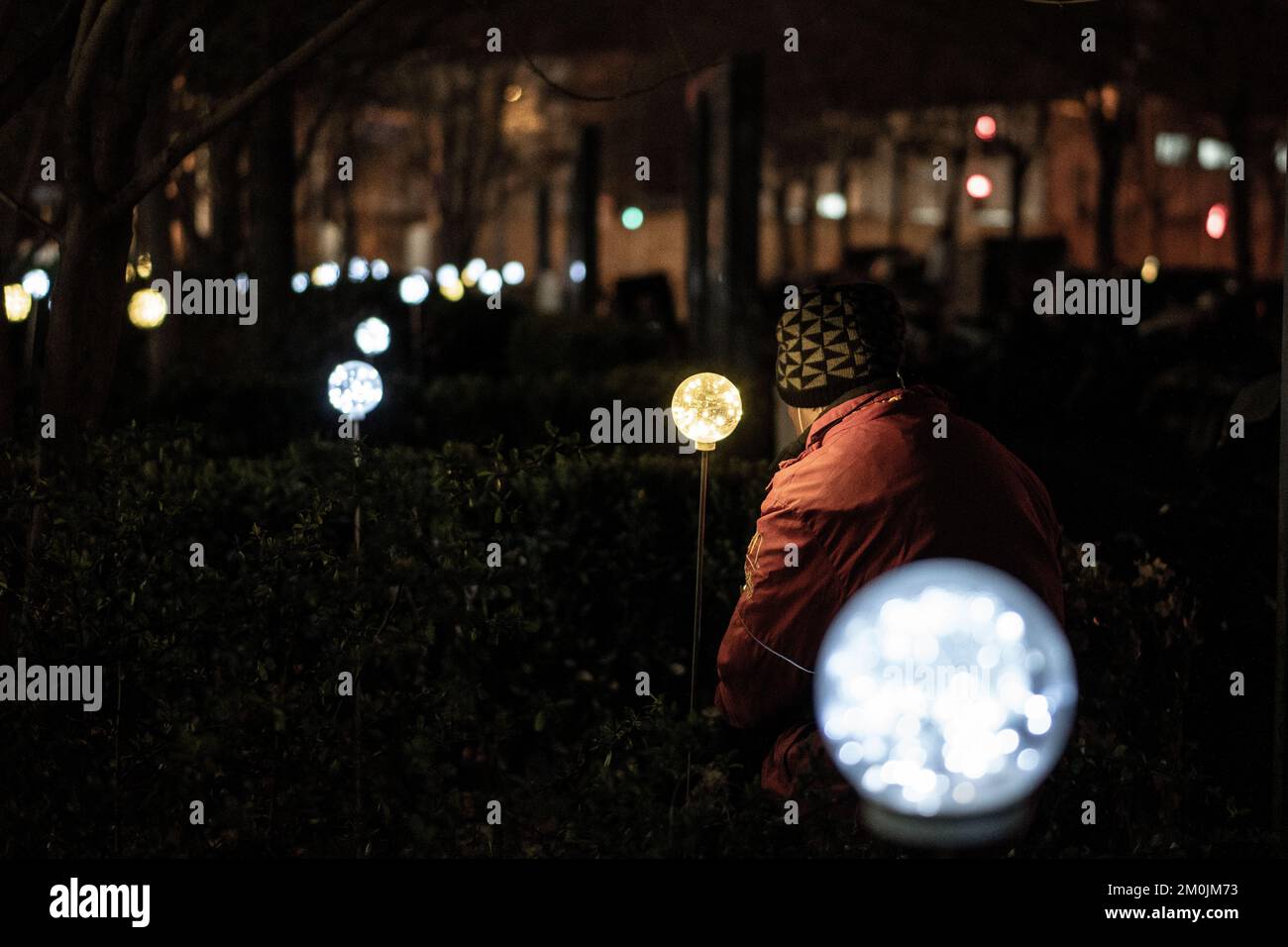 food delivery man rest in park glowing lights Stock Photo - Alamy
