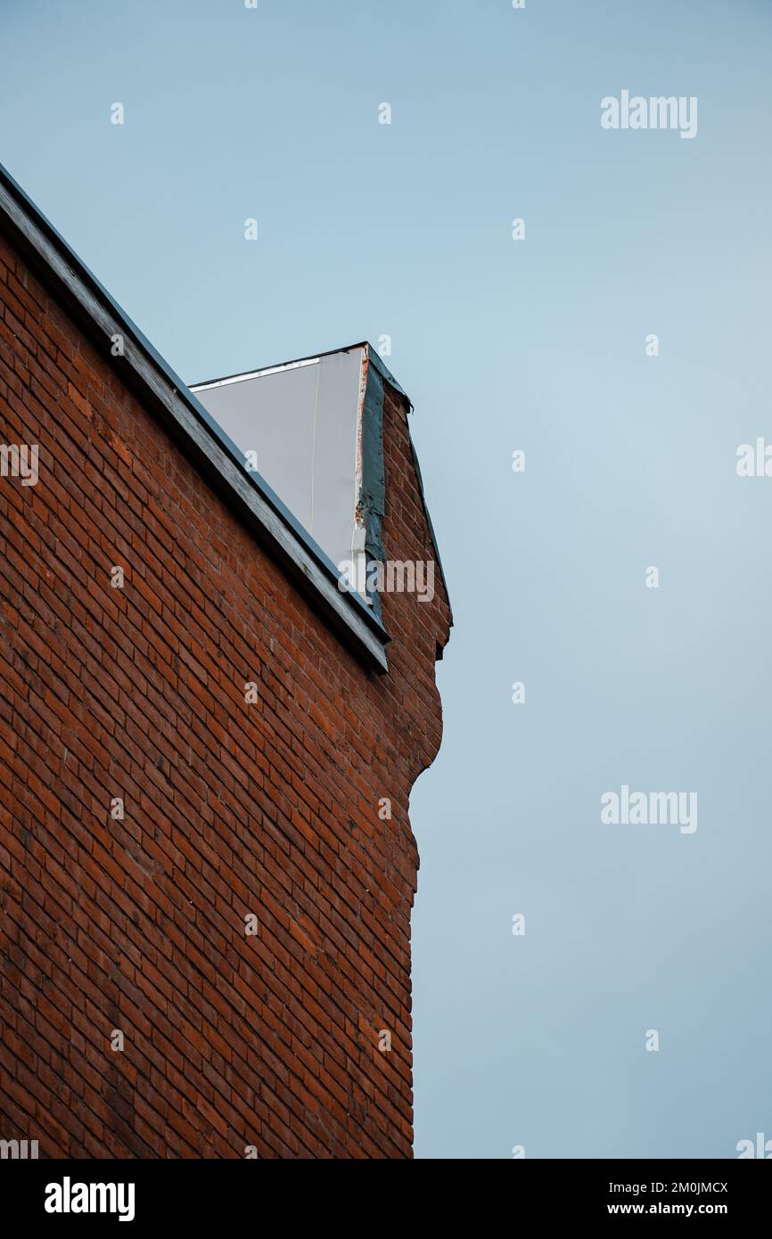 Upper corner of irregular red brick wall Stock Photo - Alamy