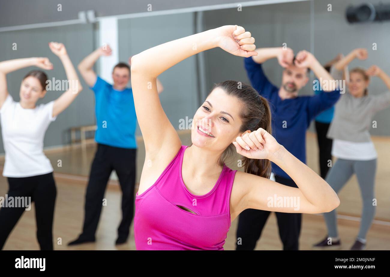 Woman training at group dance class Stock Photo - Alamy