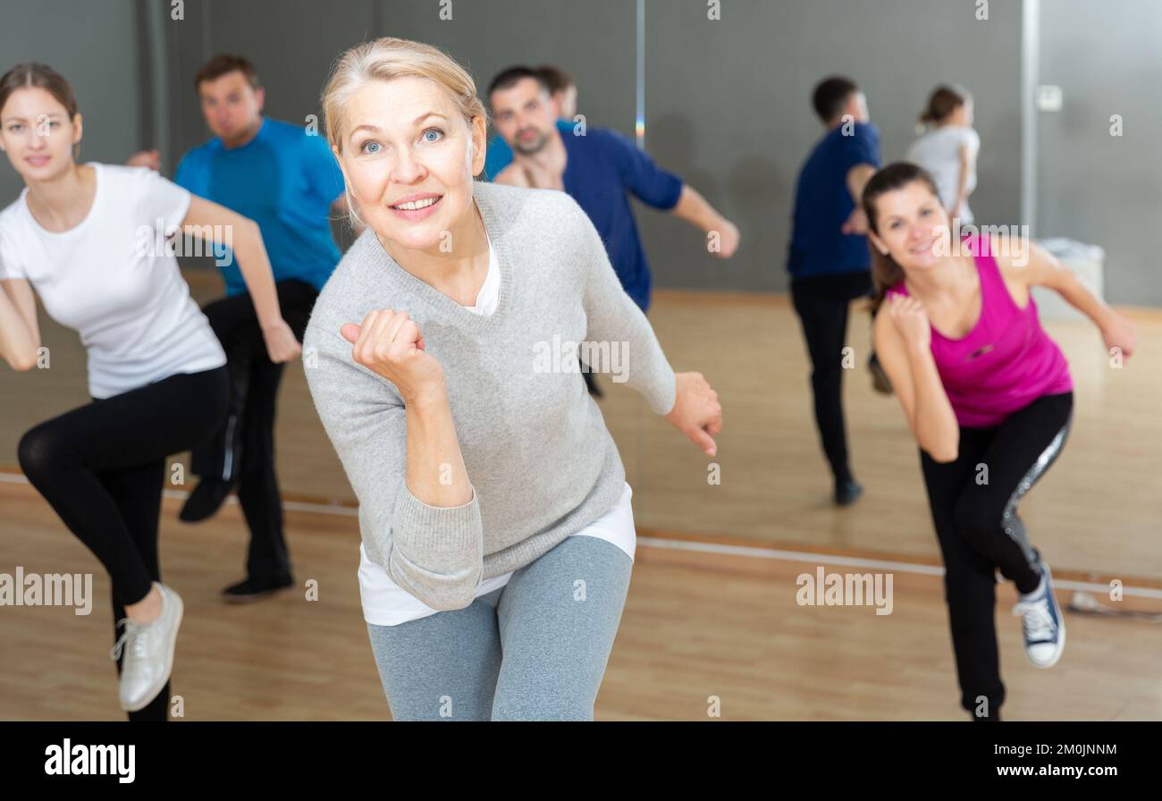 Middle aged woman enjoying active dances Stock Photo - Alamy