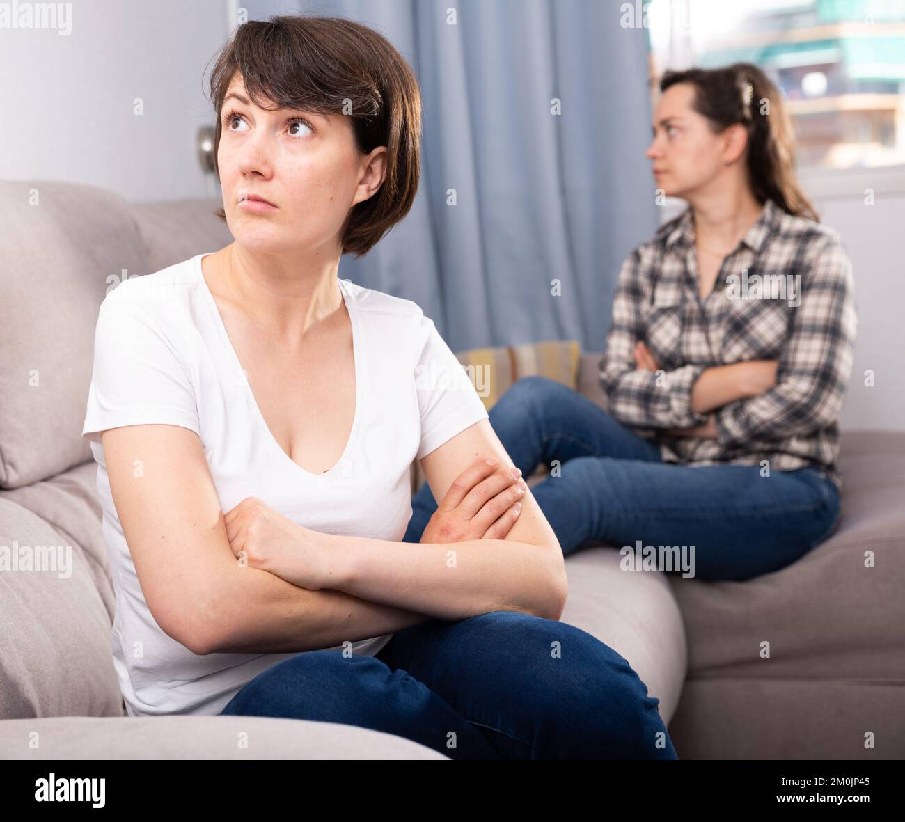 Silent resentment between sisters Stock Photo - Alamy