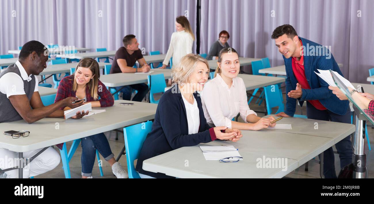 Adult students discussing lesson Stock Photo - Alamy