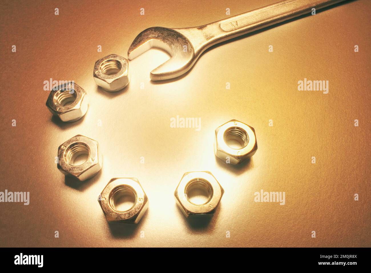 Spanner and Nuts on Warm Background Stock Photo - Alamy