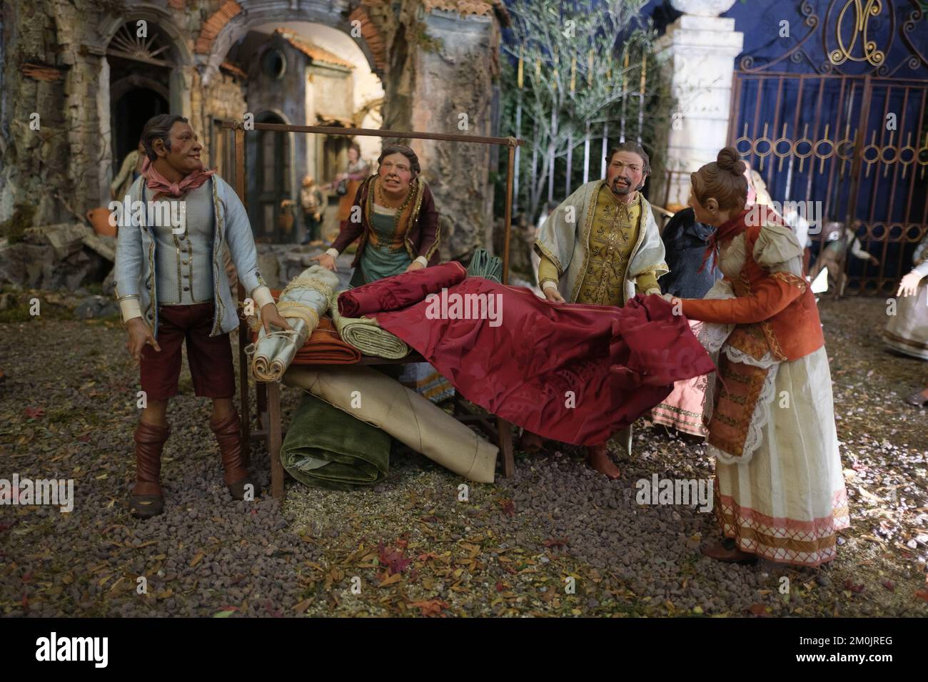 Various figures representing a scene of cloth merchants is shown in the ...