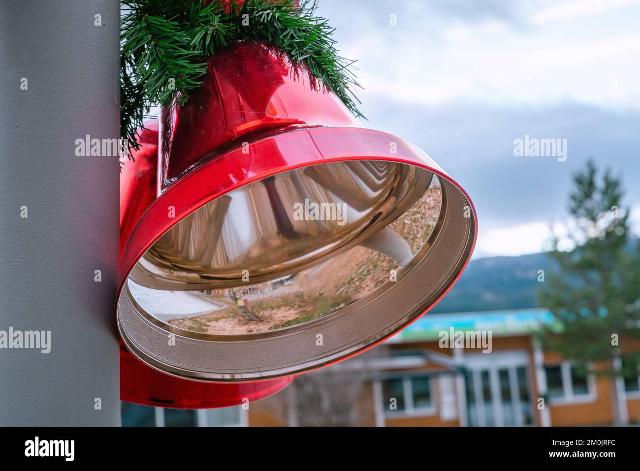 Two large Christmas red bells with red bow and pine leaves, street ...