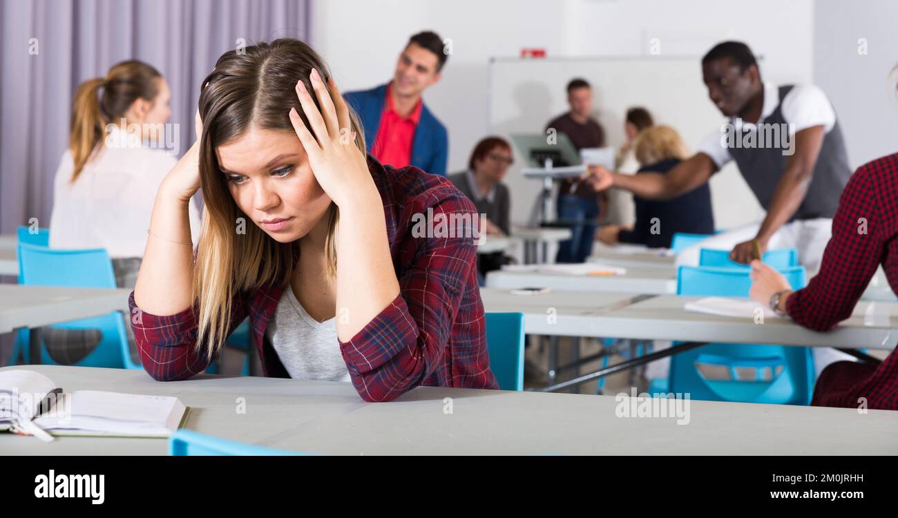 Frustrated woman student in classroom Stock Photo - Alamy