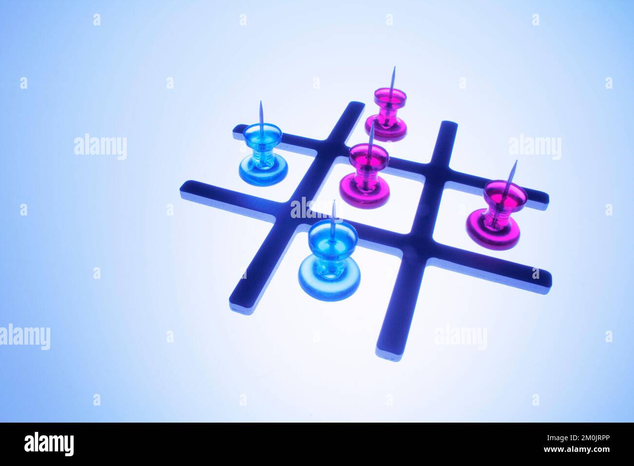 Tic-Tac-Toe with Drawing Pins on Blue Background Stock Photo - Alamy
