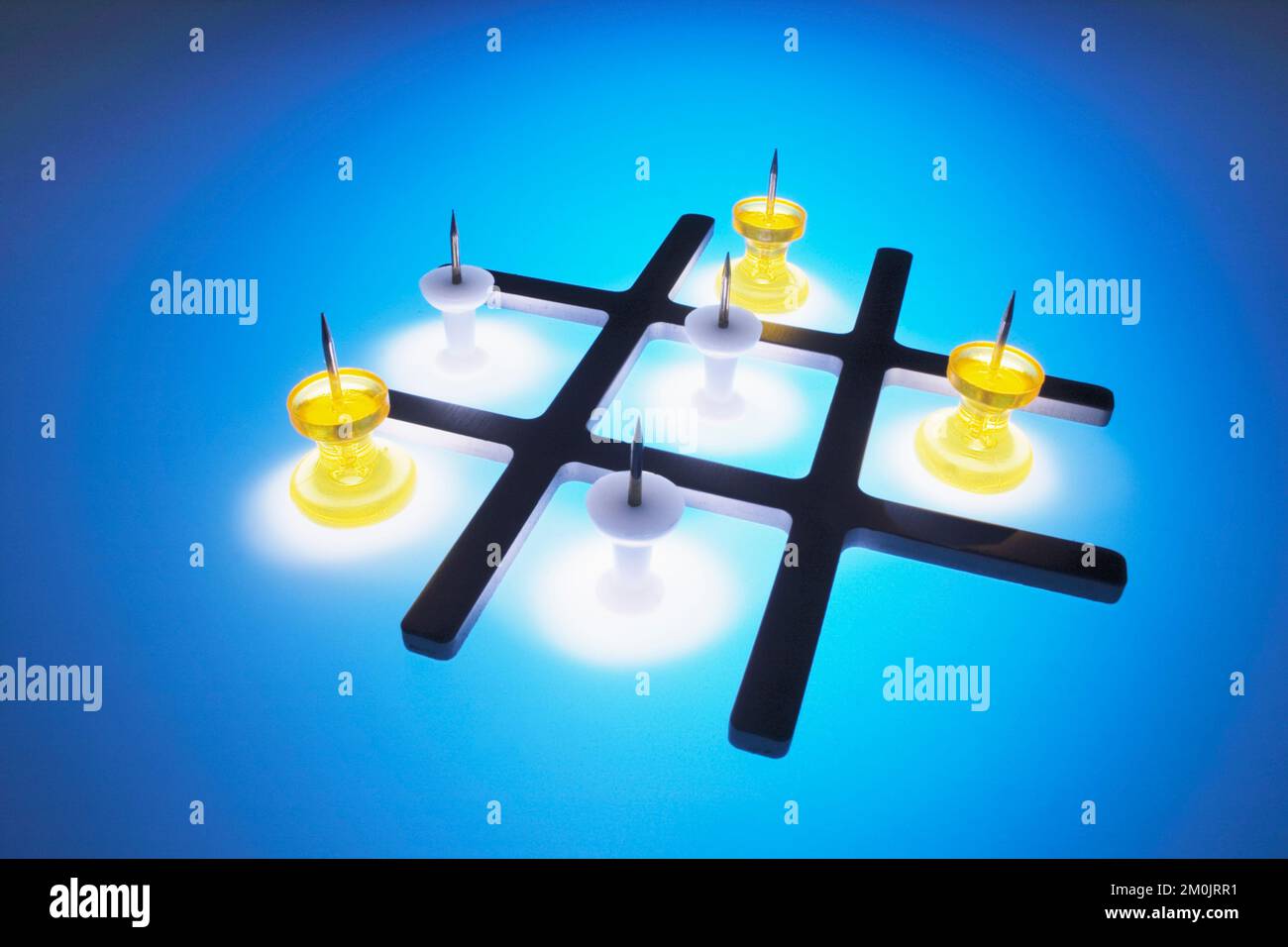 Tic-Tac-Toe with Drawing Pins on Blue Background Stock Photo - Alamy