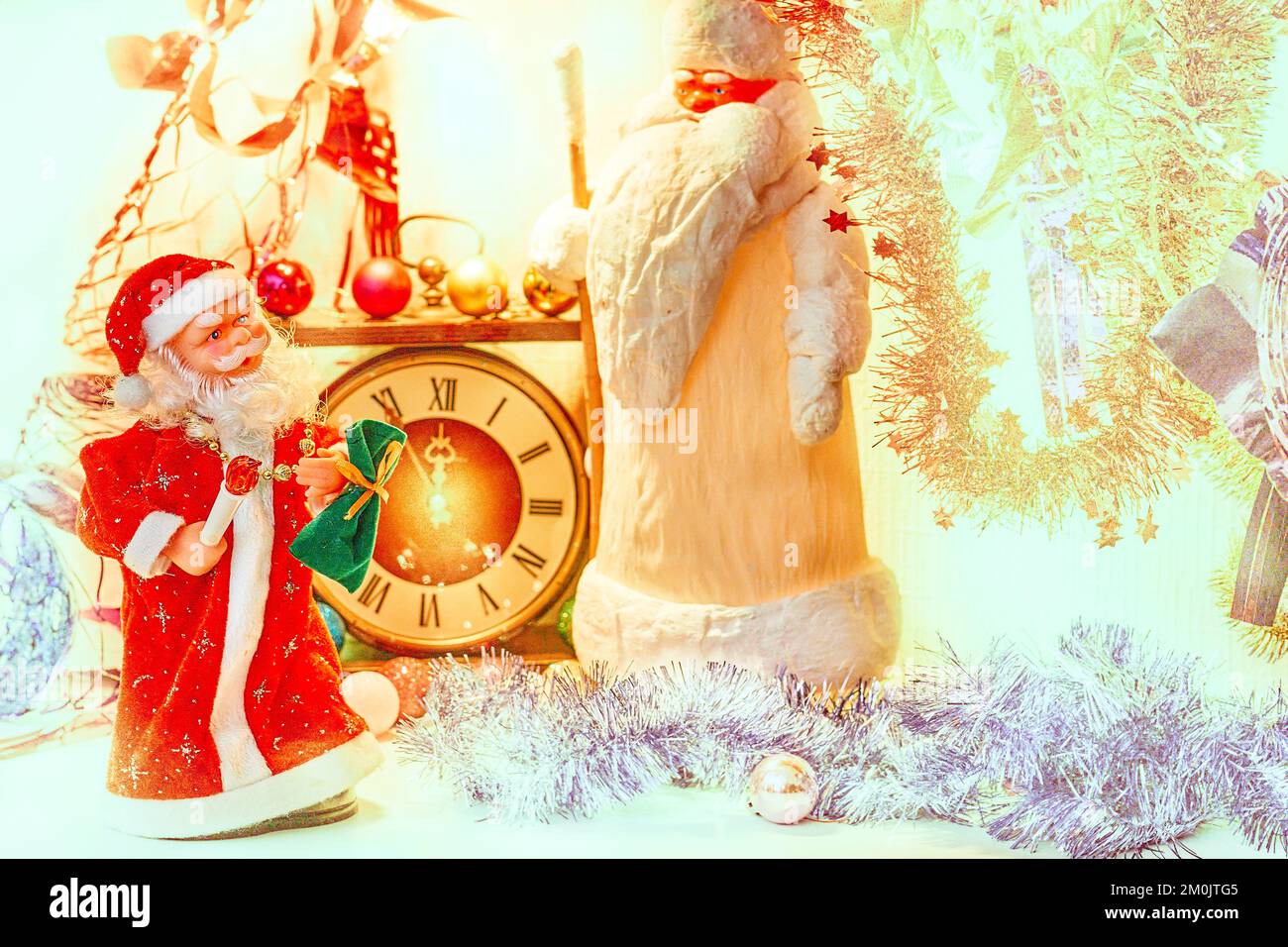 Two Santa Claus and vintage clock in golden silver Christmas New Year ...