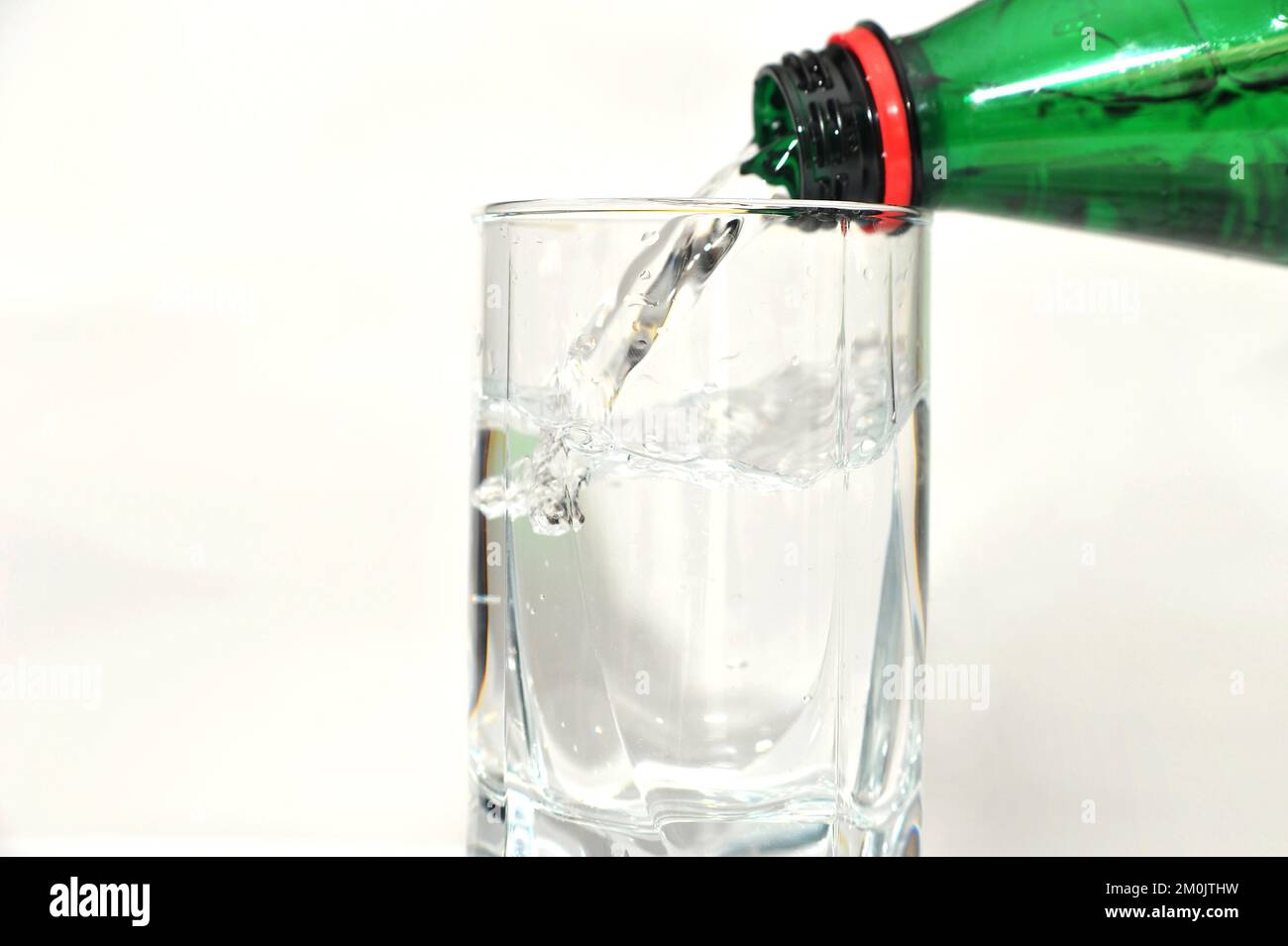 Pouring bottled mineral water for drinking into a glass Stock Photo - Alamy